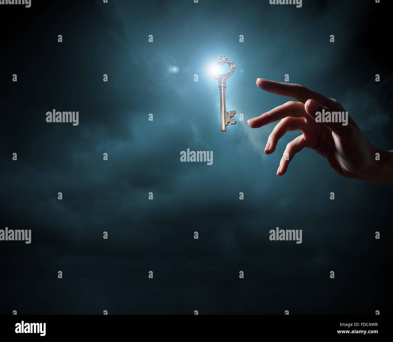 Close up of woman hand touching golden key Stock Photo - Alamy