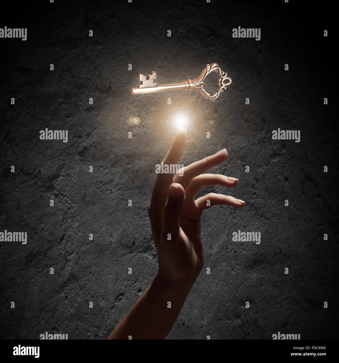 Close up of woman hand touching golden key Stock Photo - Alamy