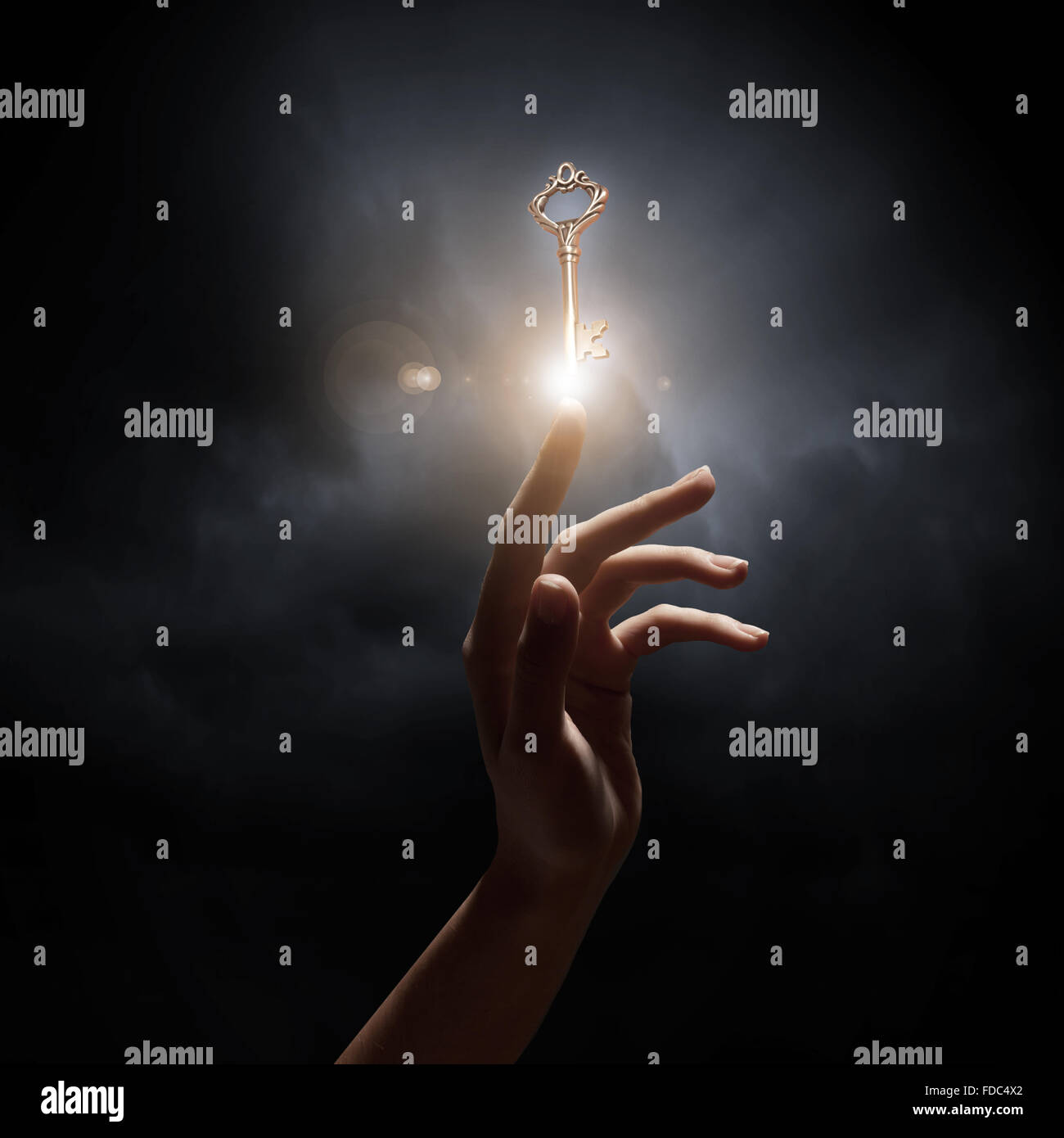 Close up of woman hand touching golden key Stock Photo - Alamy
