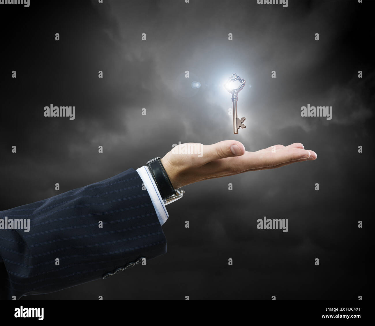 Close up of human hand holding key Stock Photo - Alamy