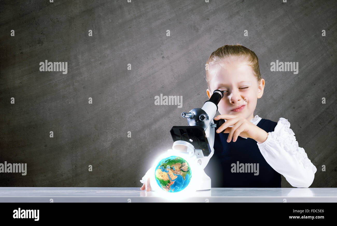 Cute girl with microscope against blackboard. Elements of this image ...