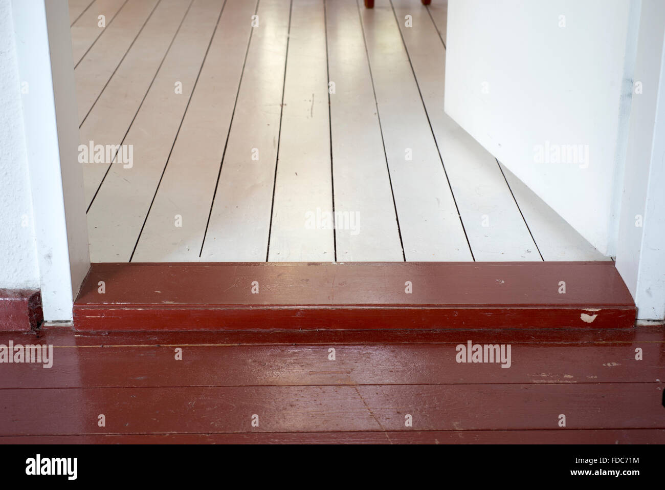 red painted doorstep before entrance to the room with white floor Stock ...