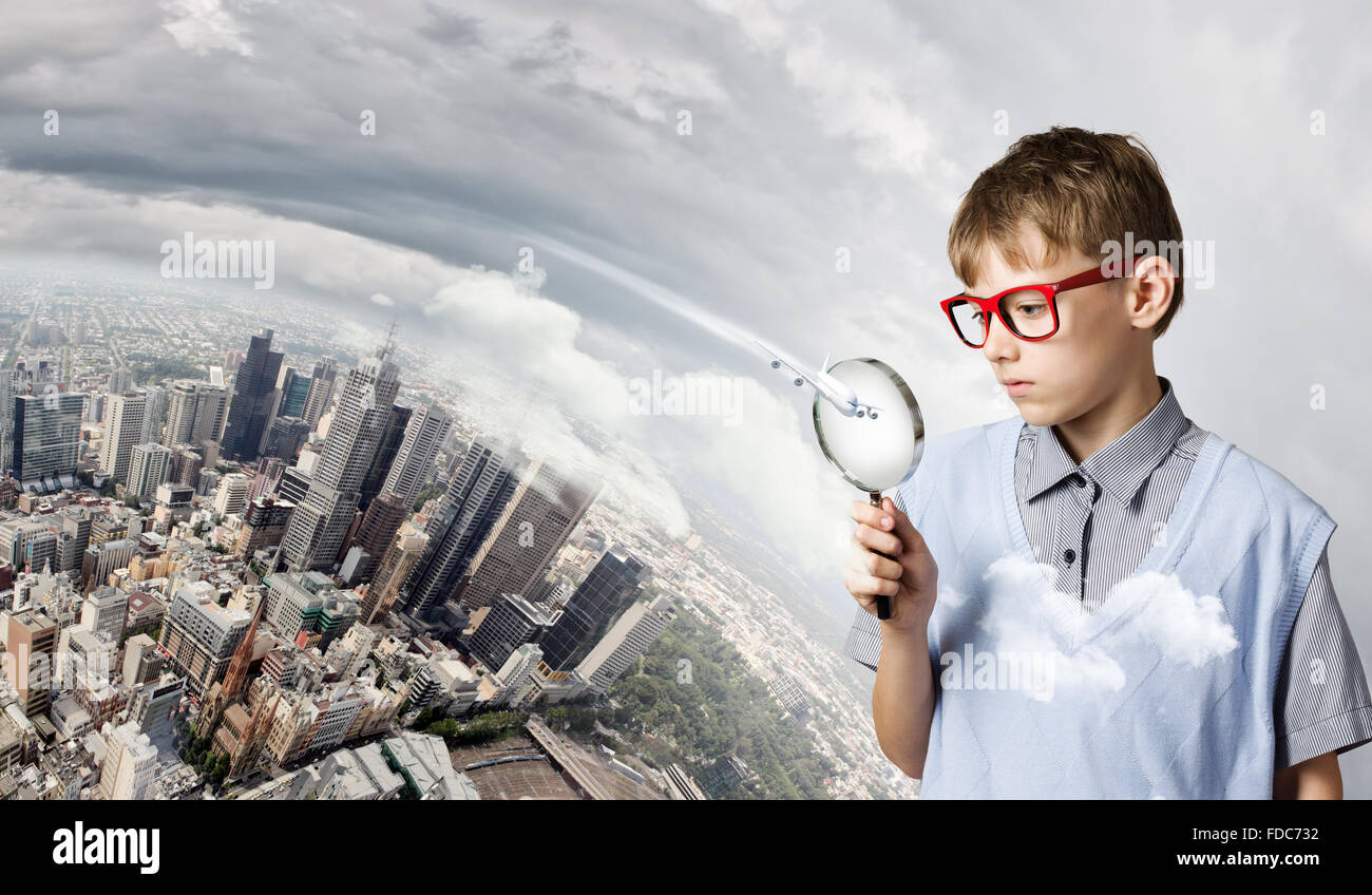 Cute school boy examining objects with magnifying glass Stock Photo - Alamy