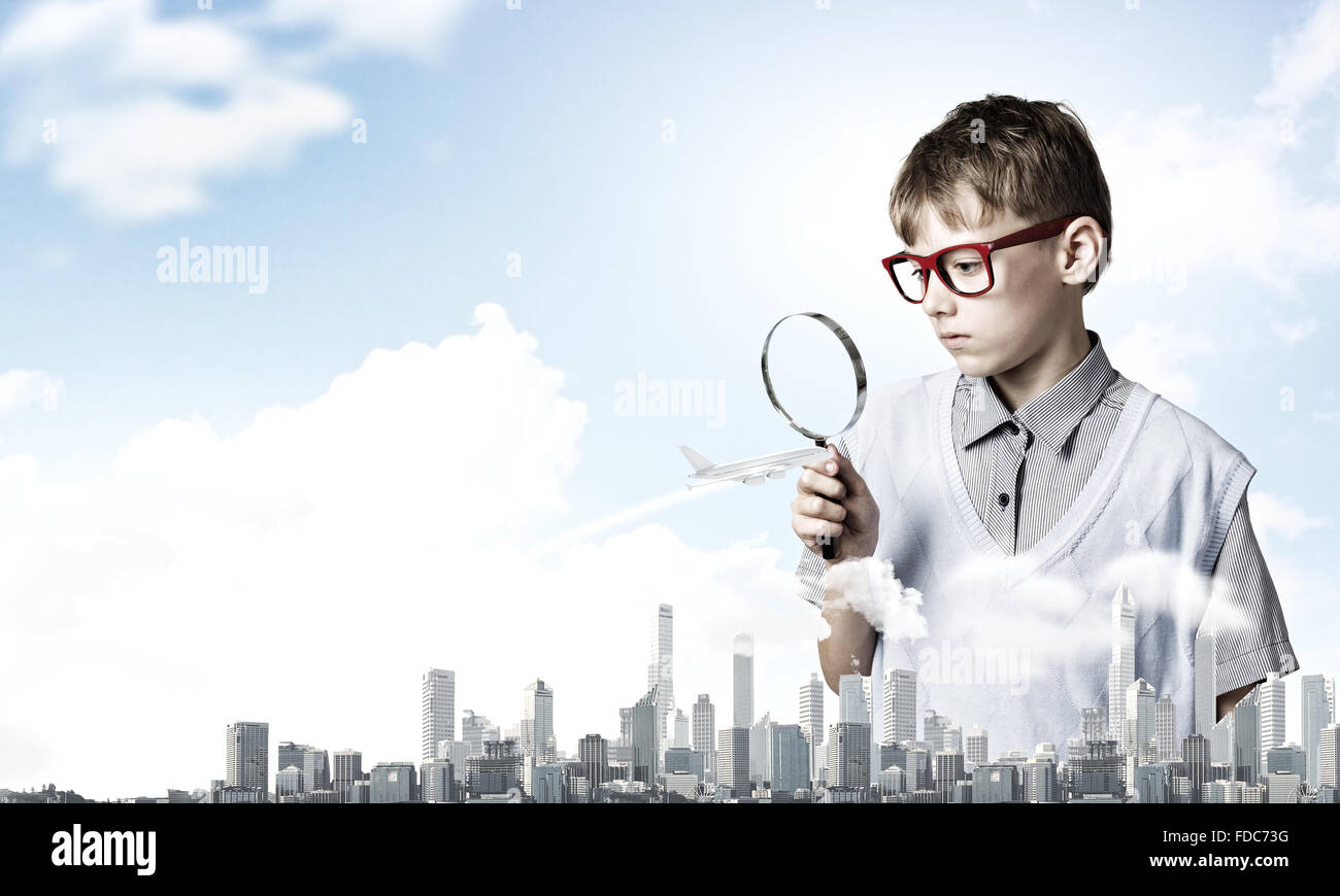 Cute school boy examining objects with magnifying glass Stock Photo - Alamy