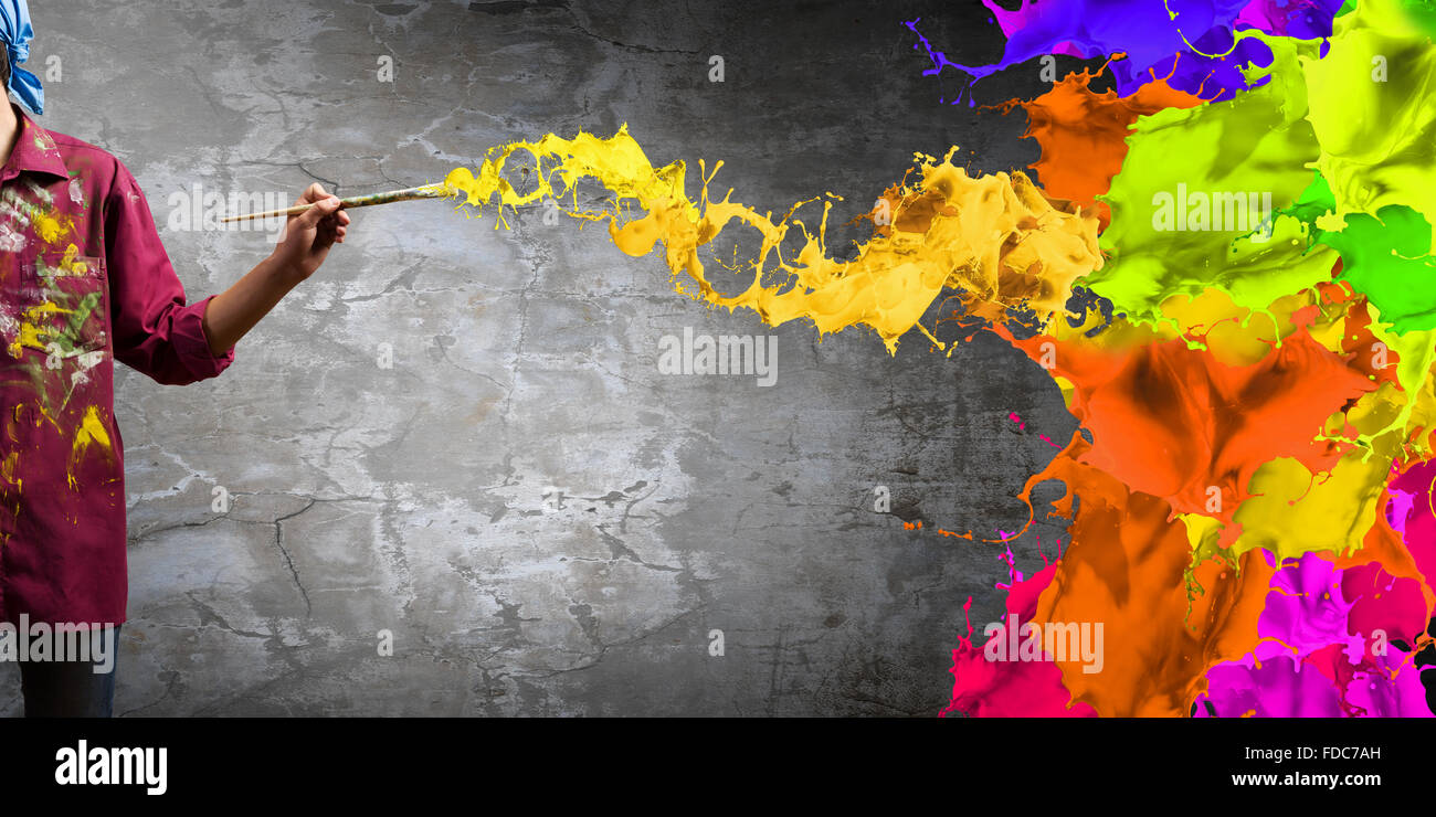 Young handsome man painter with brush in hand Stock Photo - Alamy