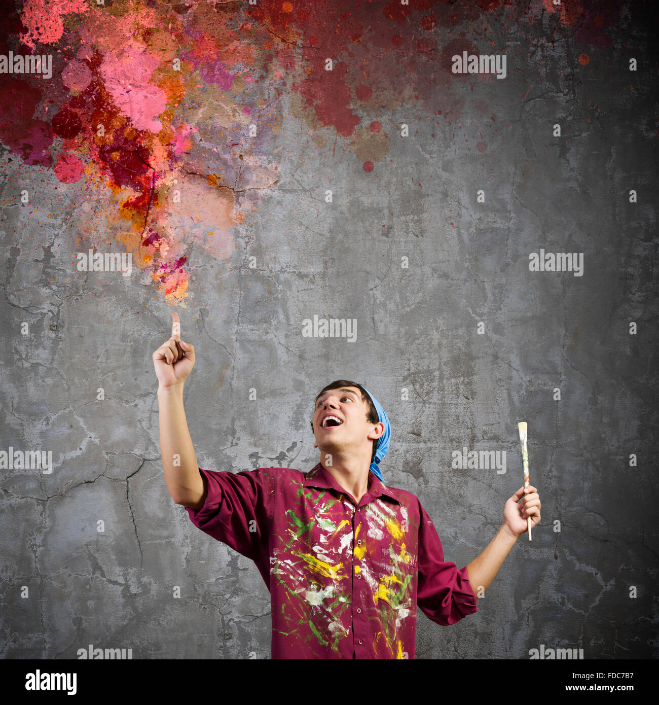 Young handsome man painter with brush in hand Stock Photo - Alamy