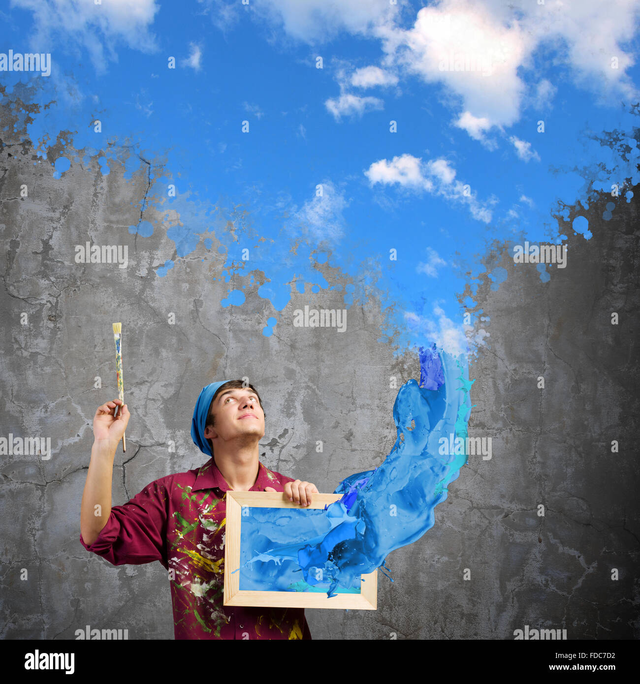 Young handsome man painter with brush in hand Stock Photo - Alamy