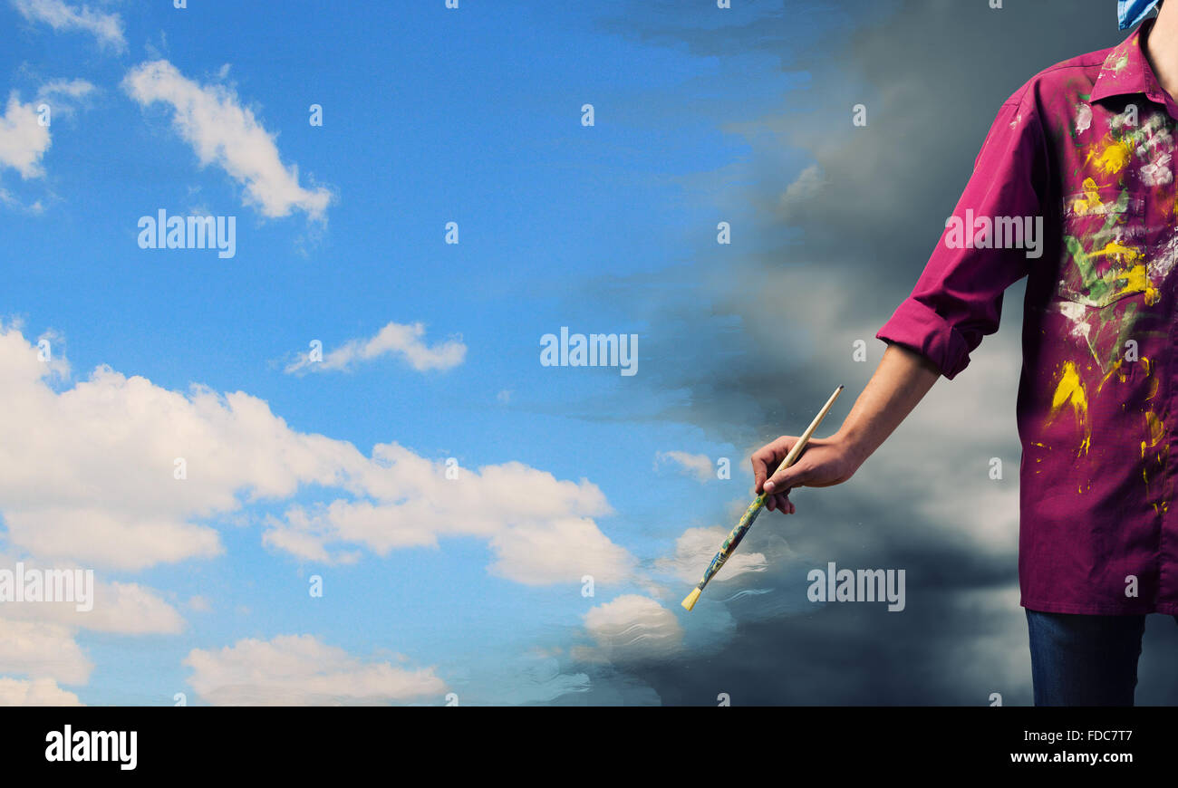Young handsome man painter with brush in hand Stock Photo - Alamy
