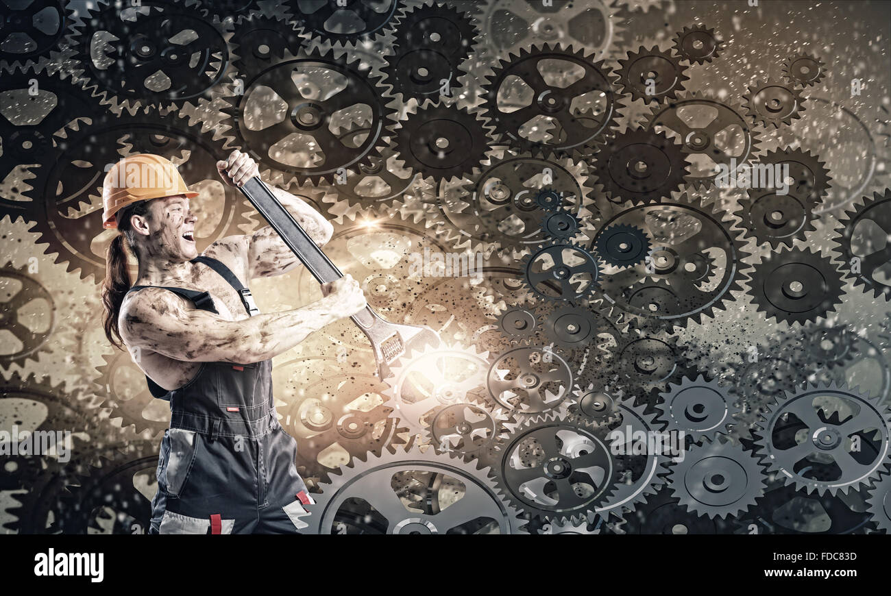 Strong man mechanic in uniform with spanner fixing mechanism Stock ...