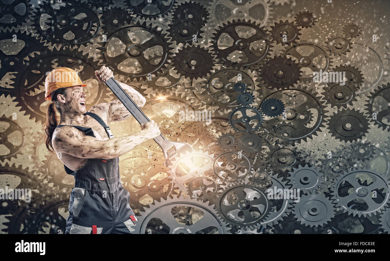 Strong man mechanic in uniform with spanner fixing mechanism Stock ...