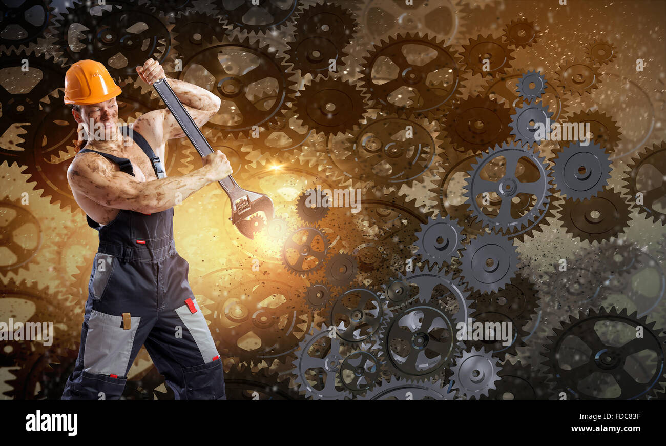 Strong man mechanic in uniform with spanner fixing mechanism Stock ...