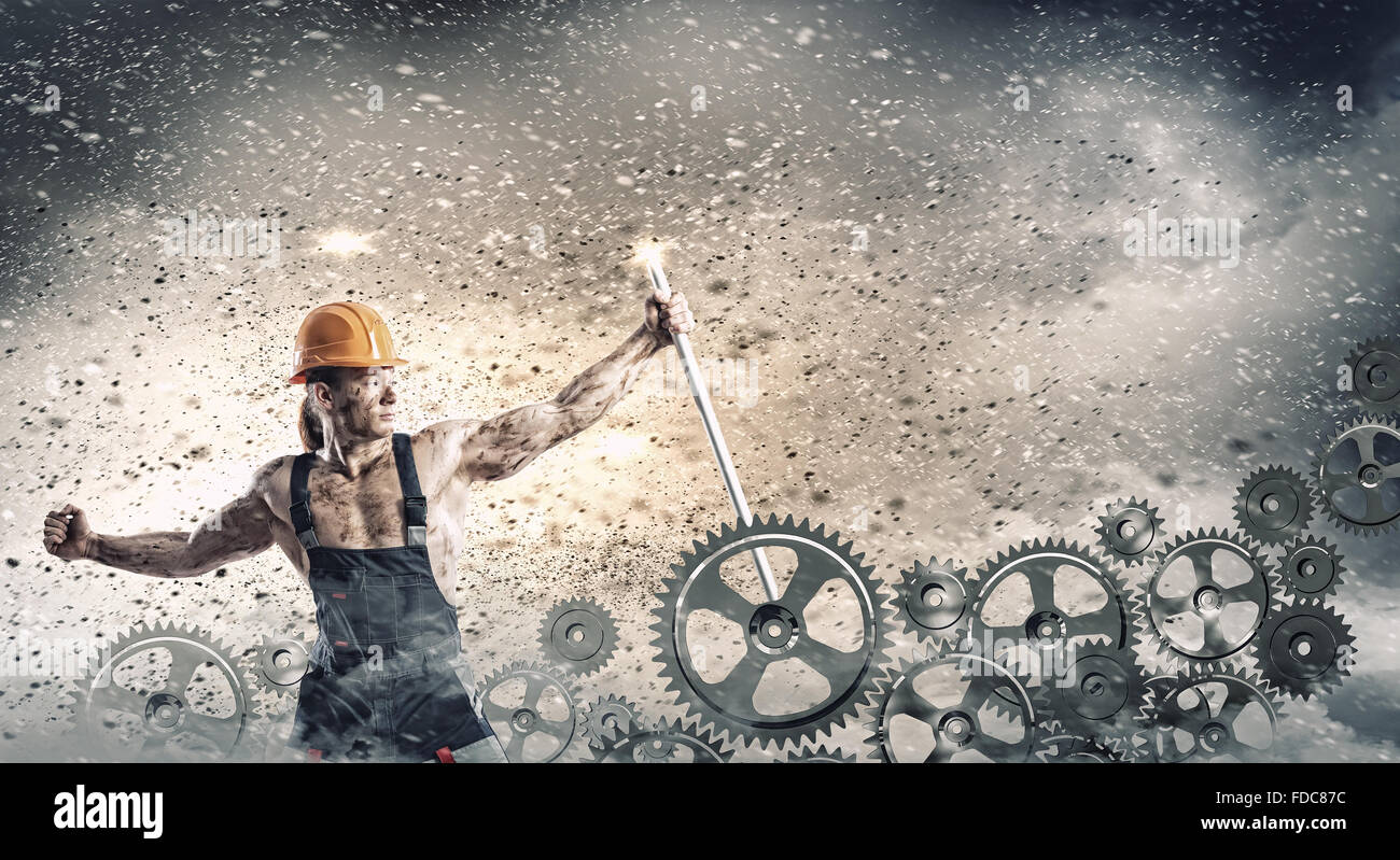 Strong man mechanic in uniform with spanner fixing mechanism Stock ...