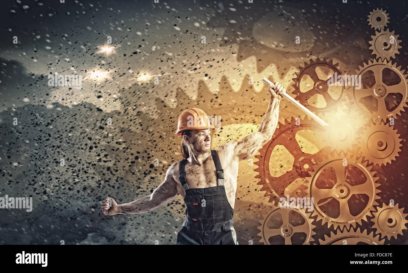 Strong man mechanic in uniform with spanner fixing mechanism Stock ...