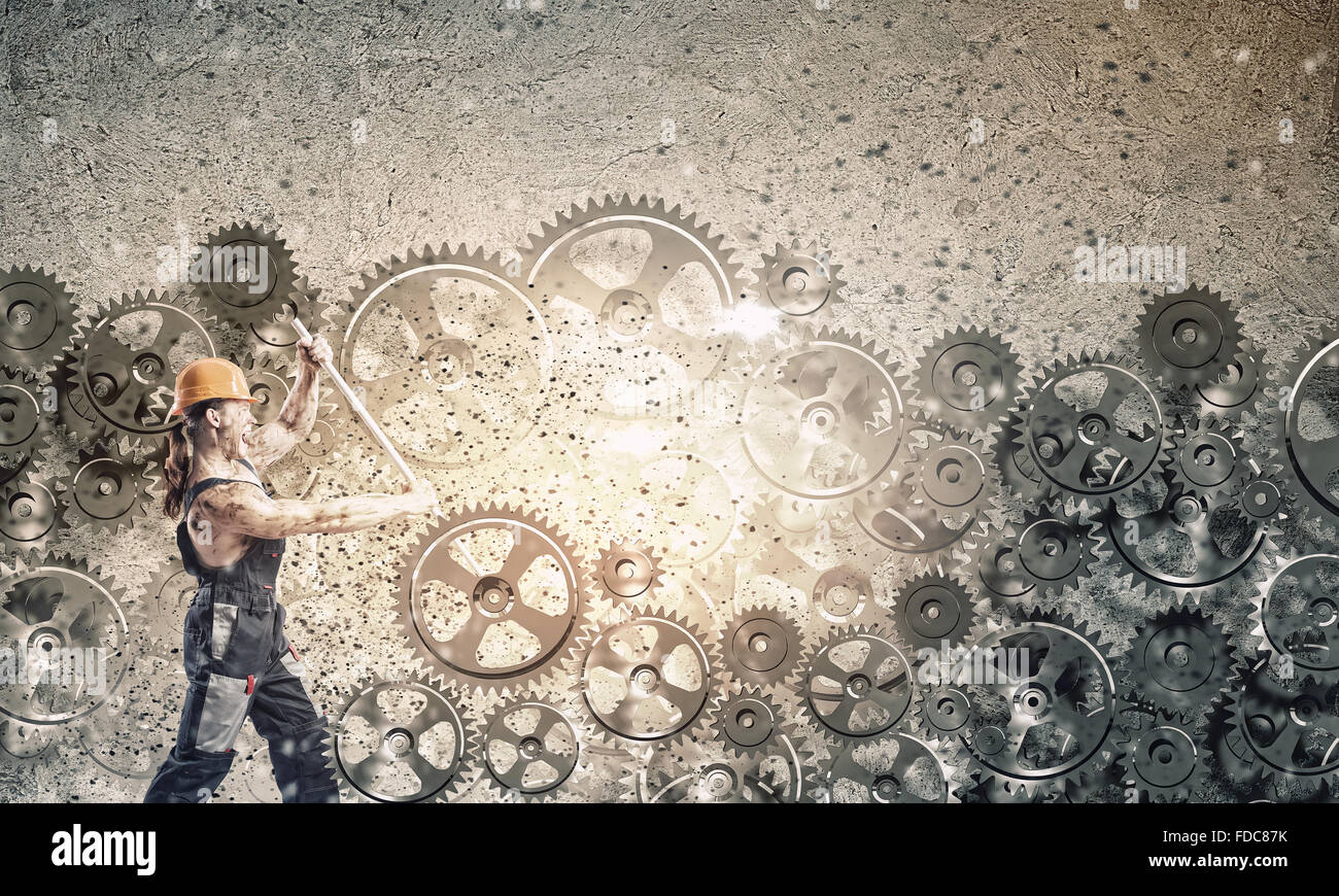 Strong man mechanic in uniform with spanner fixing mechanism Stock ...