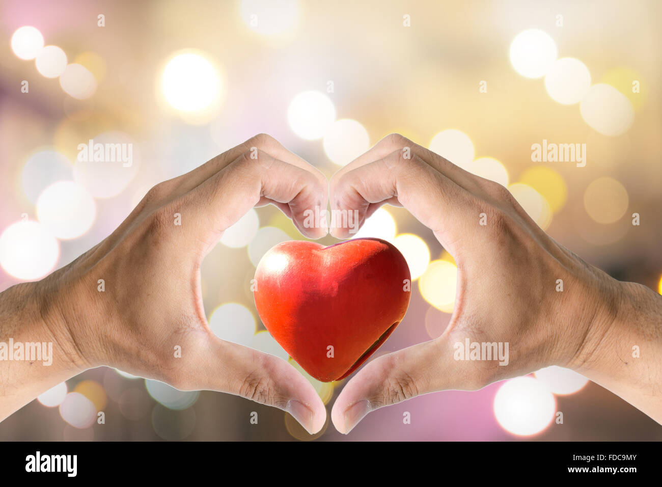 Making a heart shape with the hand symbol Stock Photo - Alamy