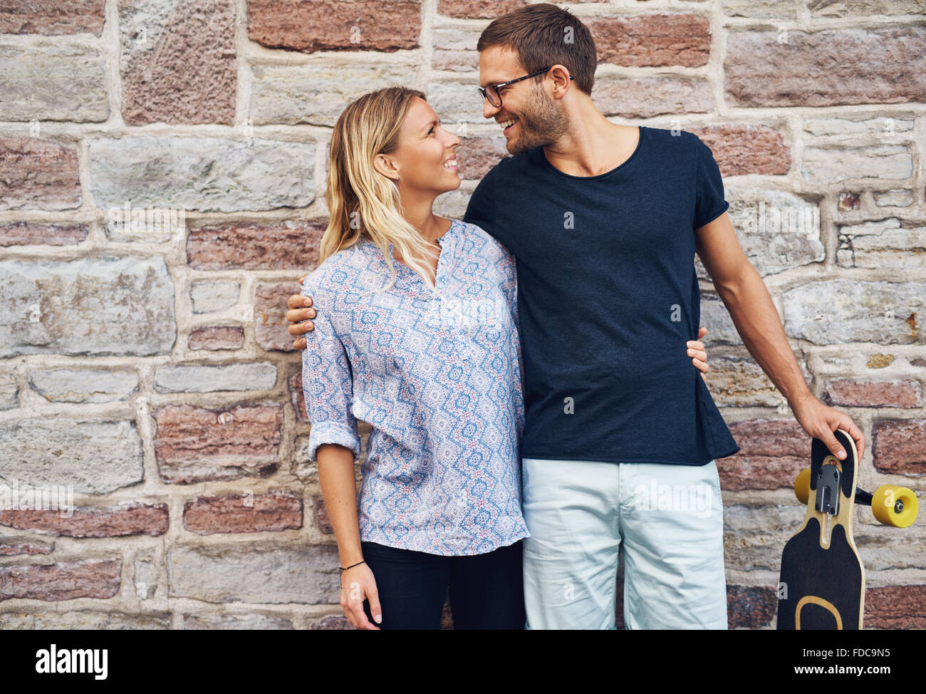 Three Quarter Shot of a Sweet Lovers Smiling Each Other Against ...