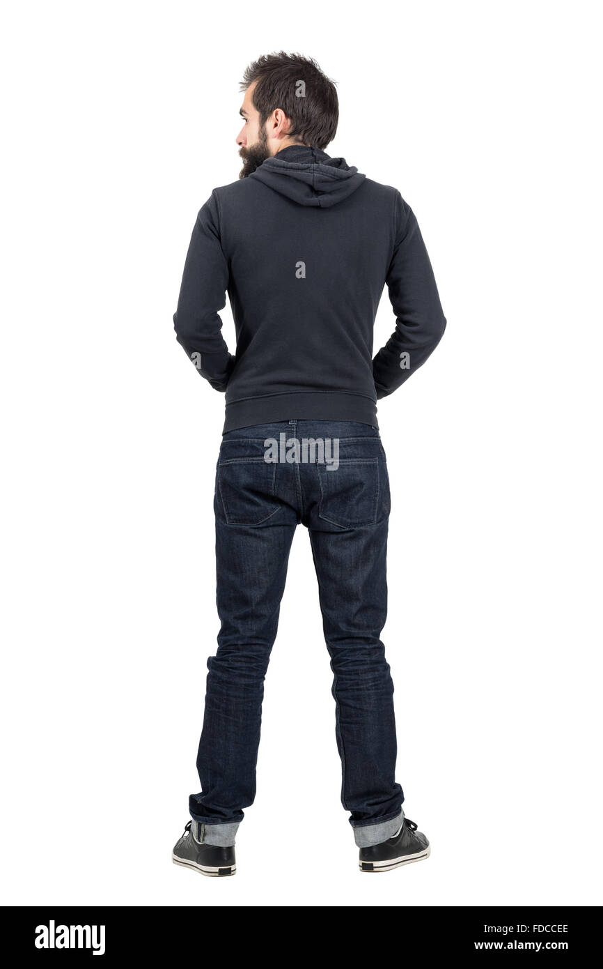 Rear back view of bearded man in black hooded sweatshirt looking away ...