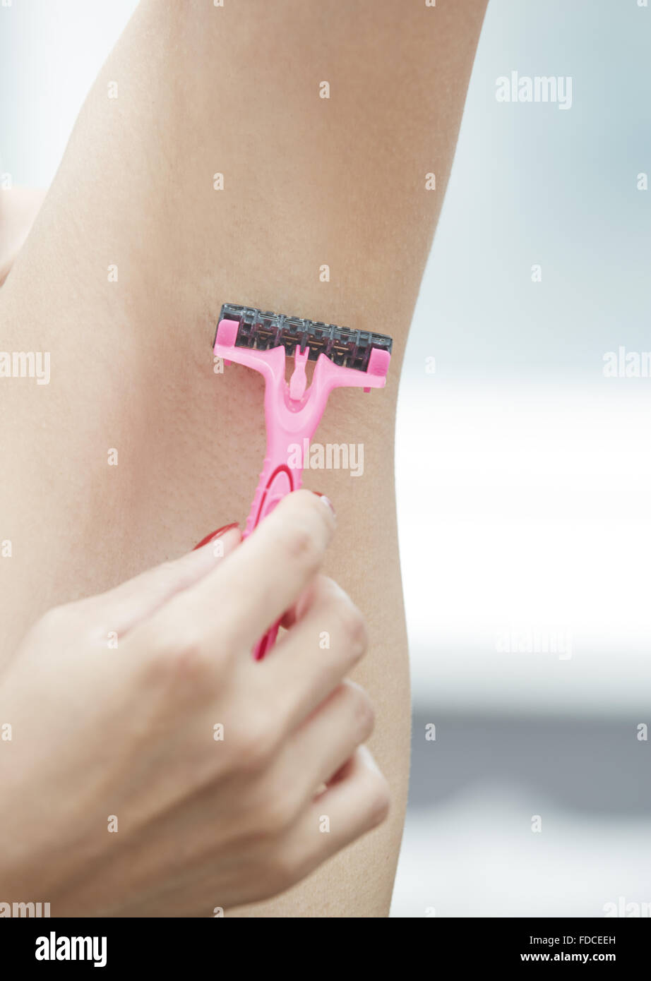 Young woman shaving armpit hi-res stock photography and images - Alamy