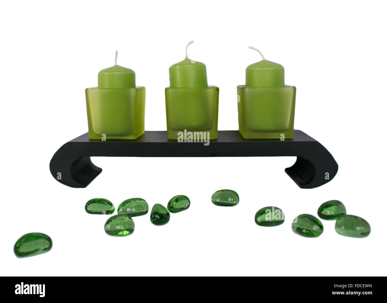 green candle in a candlestick and green stones Stock Photo - Alamy