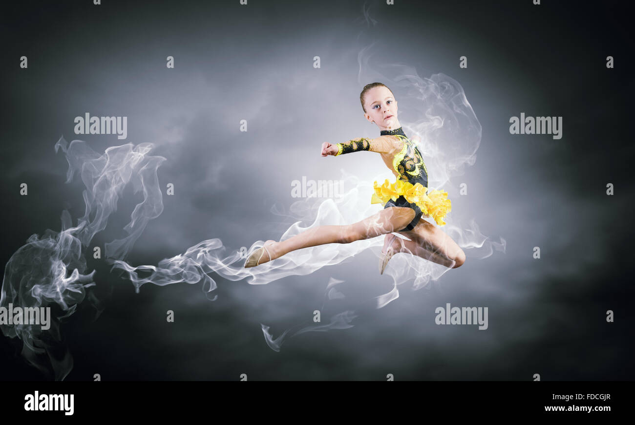 Little cute girl gymnast making high jump Stock Photo - Alamy