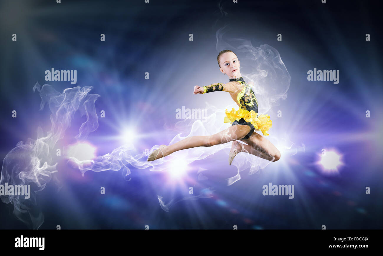 Little cute girl gymnast making high jump Stock Photo - Alamy