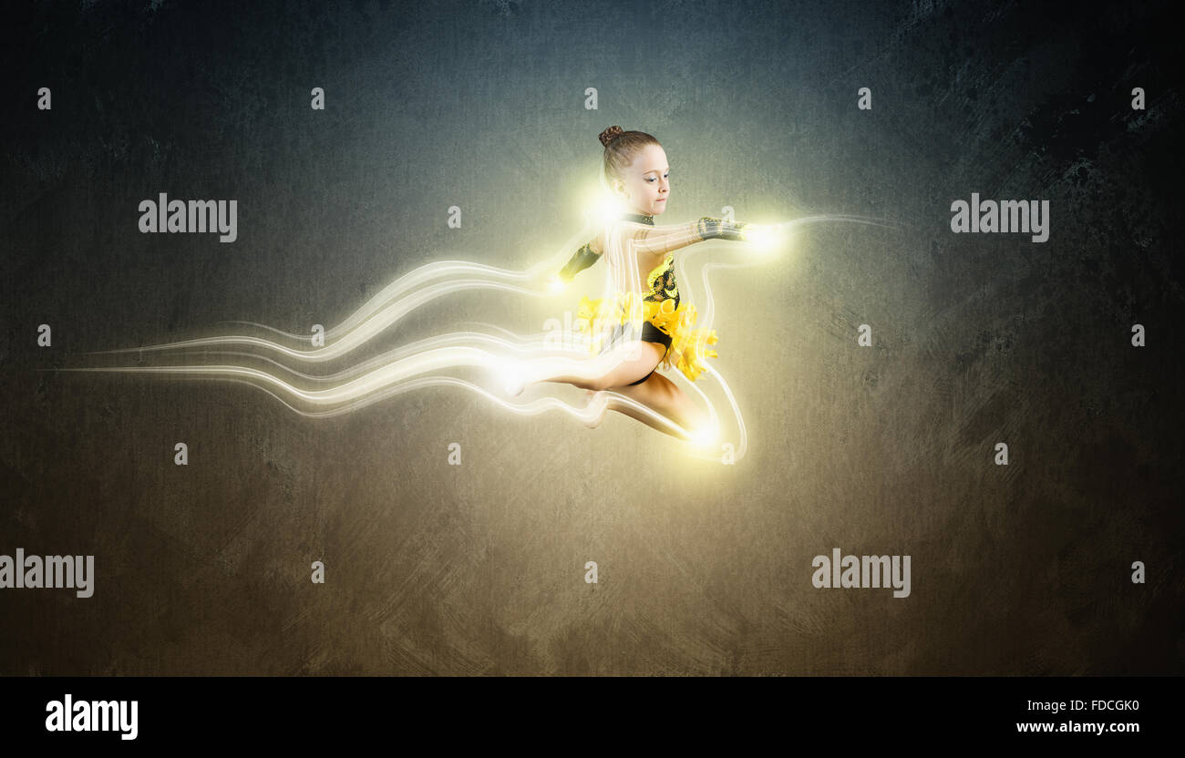 Little cute girl gymnast making high jump Stock Photo - Alamy