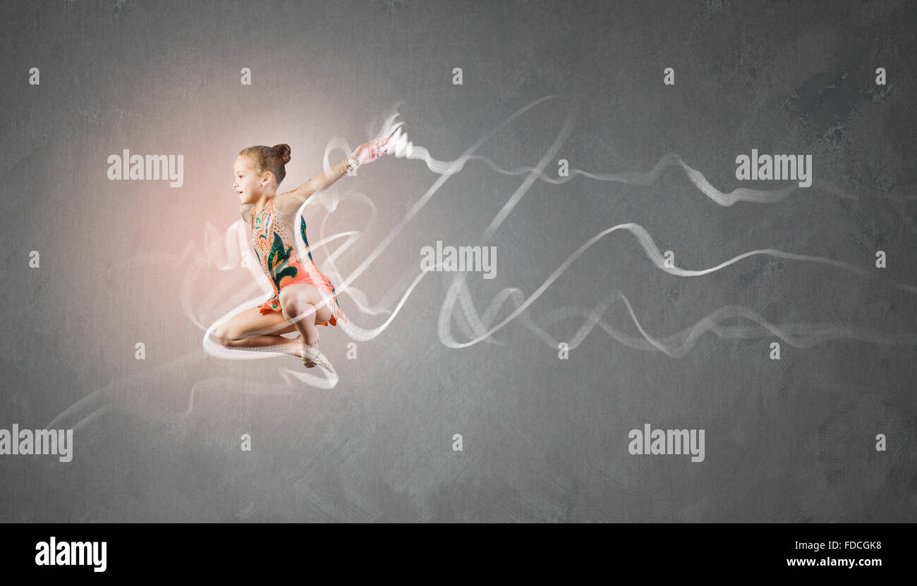 Little cute girl gymnast making high jump Stock Photo - Alamy