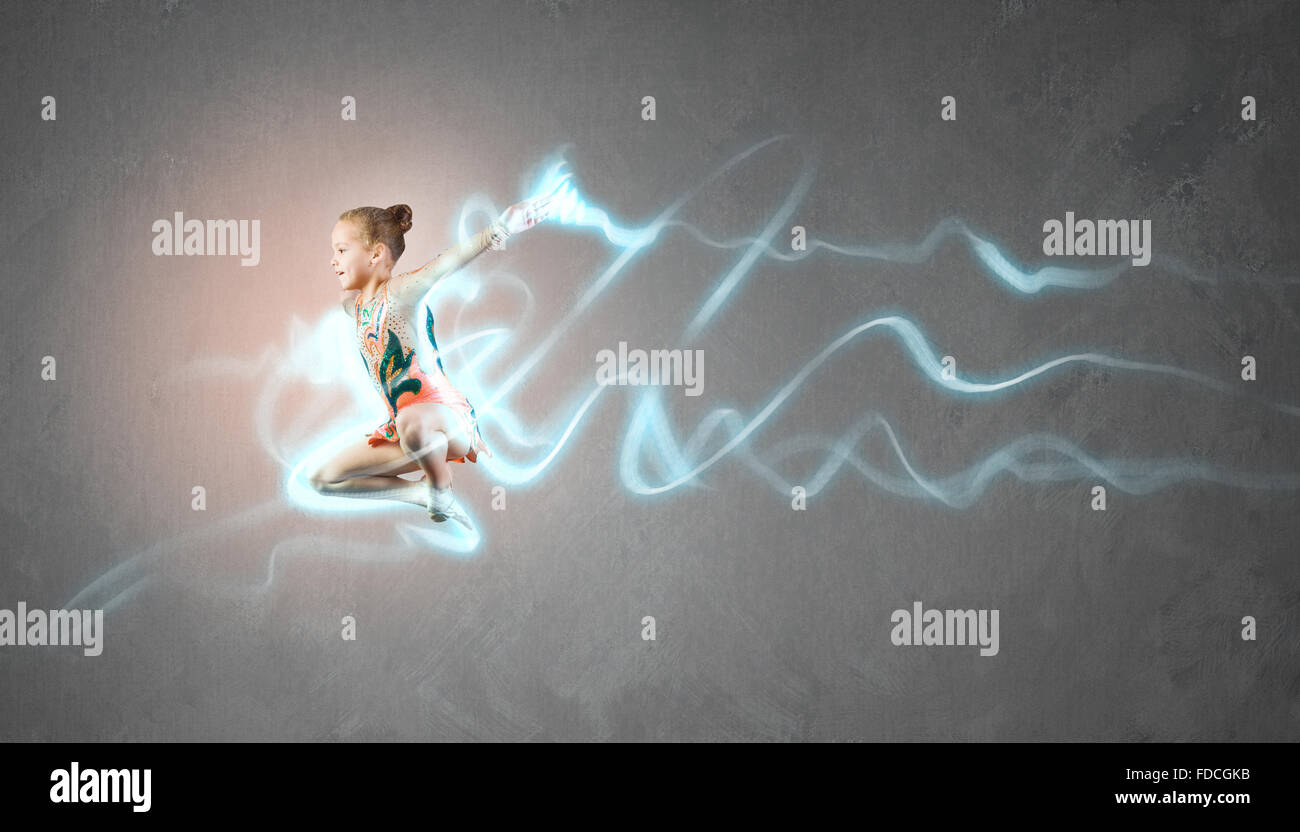 Little cute girl gymnast making high jump Stock Photo - Alamy