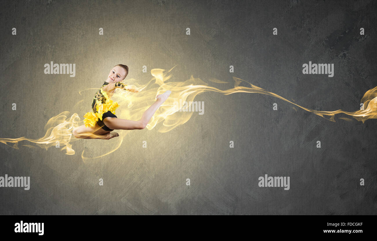 Little cute girl gymnast making high jump Stock Photo - Alamy