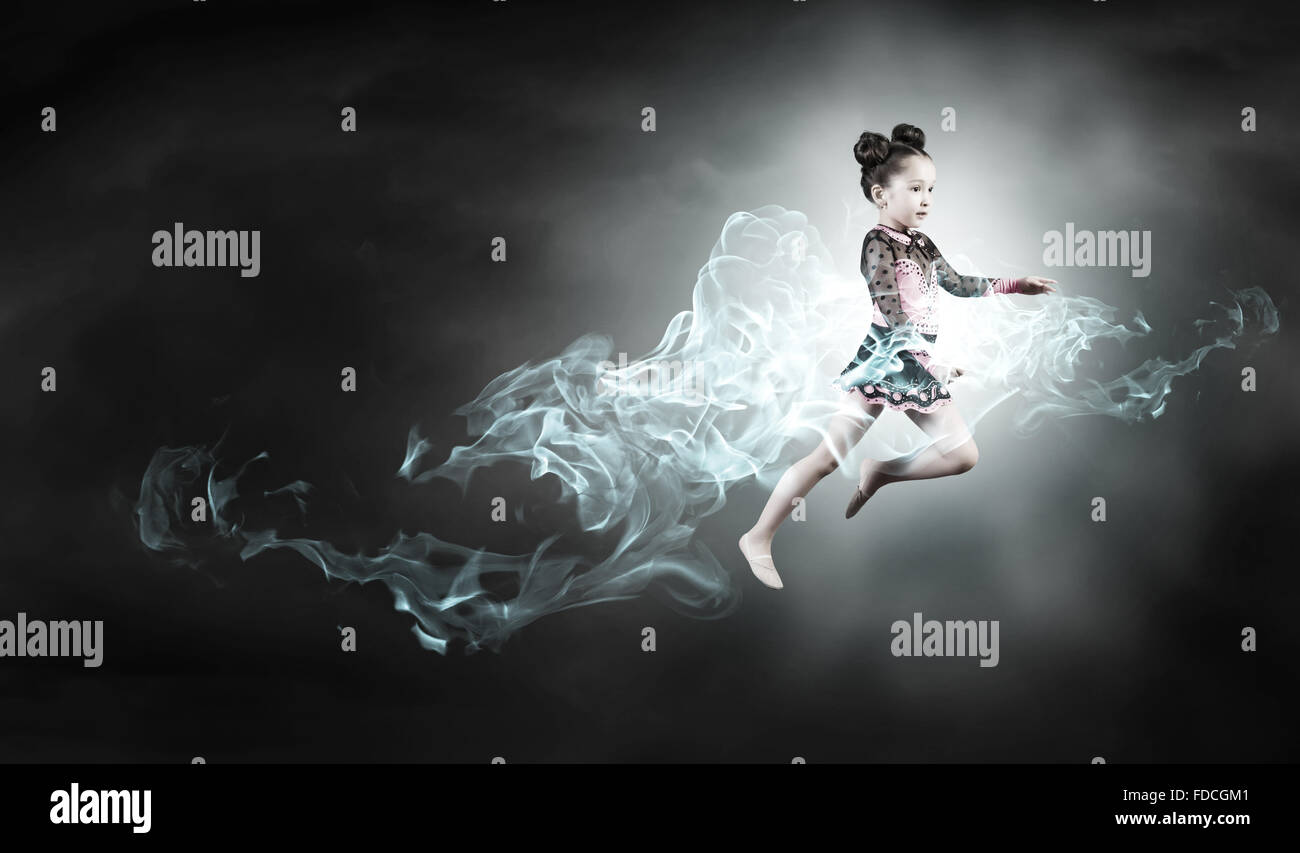 Little cute girl gymnast making high jump Stock Photo - Alamy