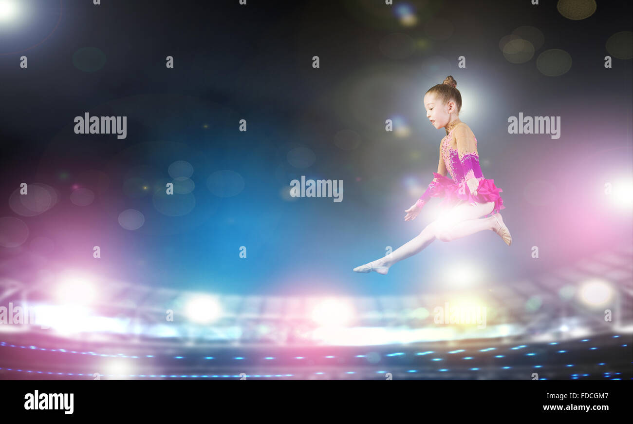 Little cute girl gymnast making high jump Stock Photo - Alamy