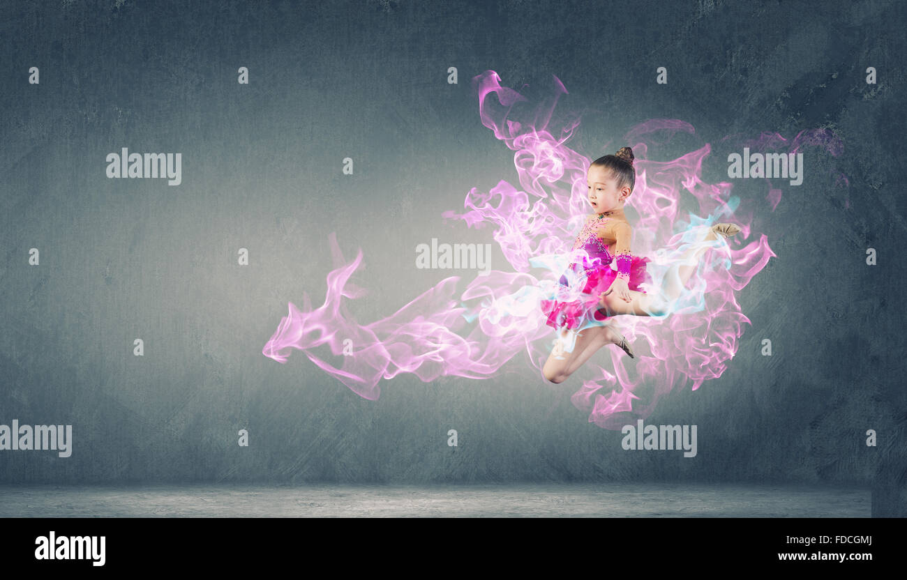 Little cute girl gymnast making high jump Stock Photo - Alamy