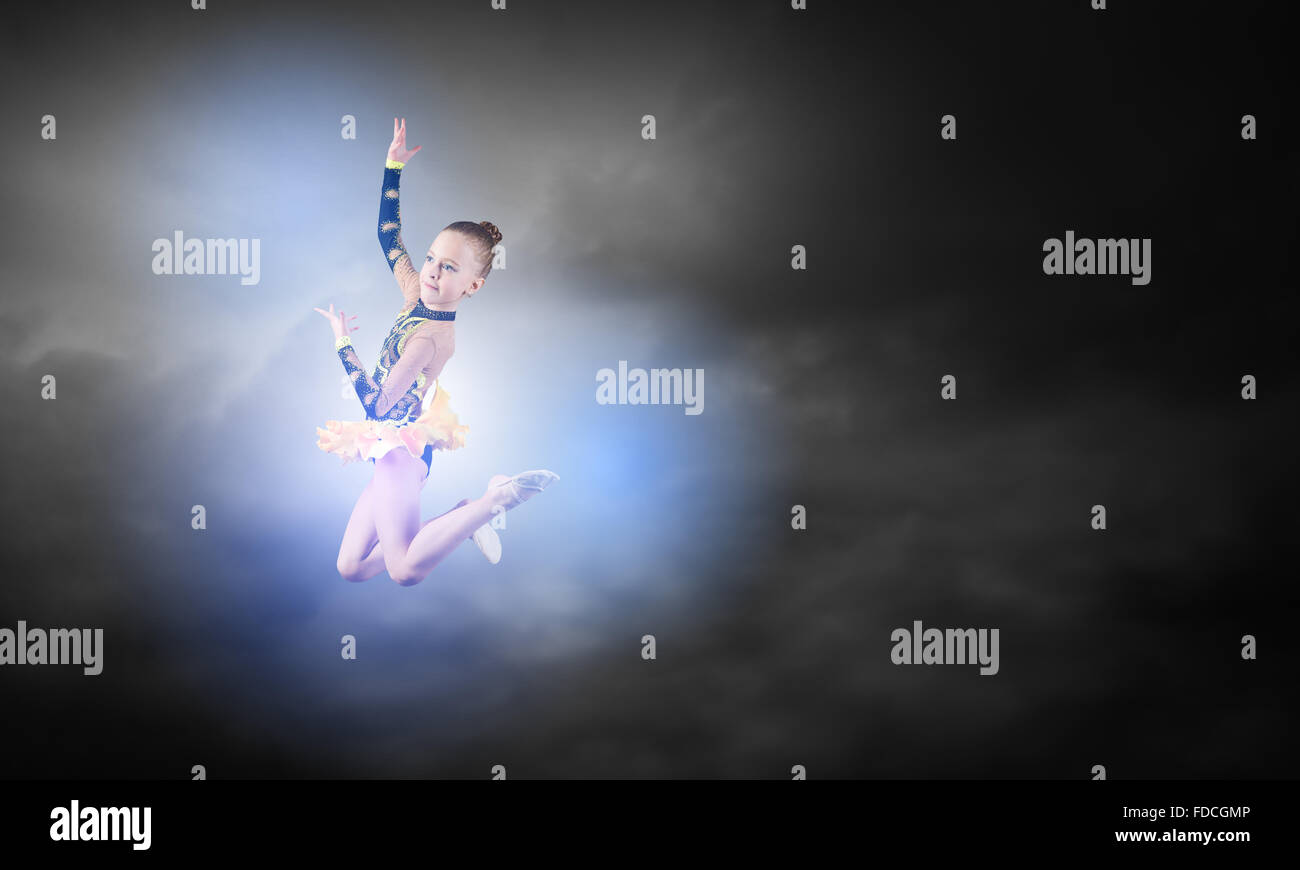 Little cute girl gymnast making high jump Stock Photo - Alamy