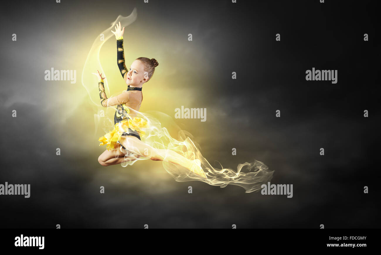 Little cute girl gymnast making high jump Stock Photo - Alamy