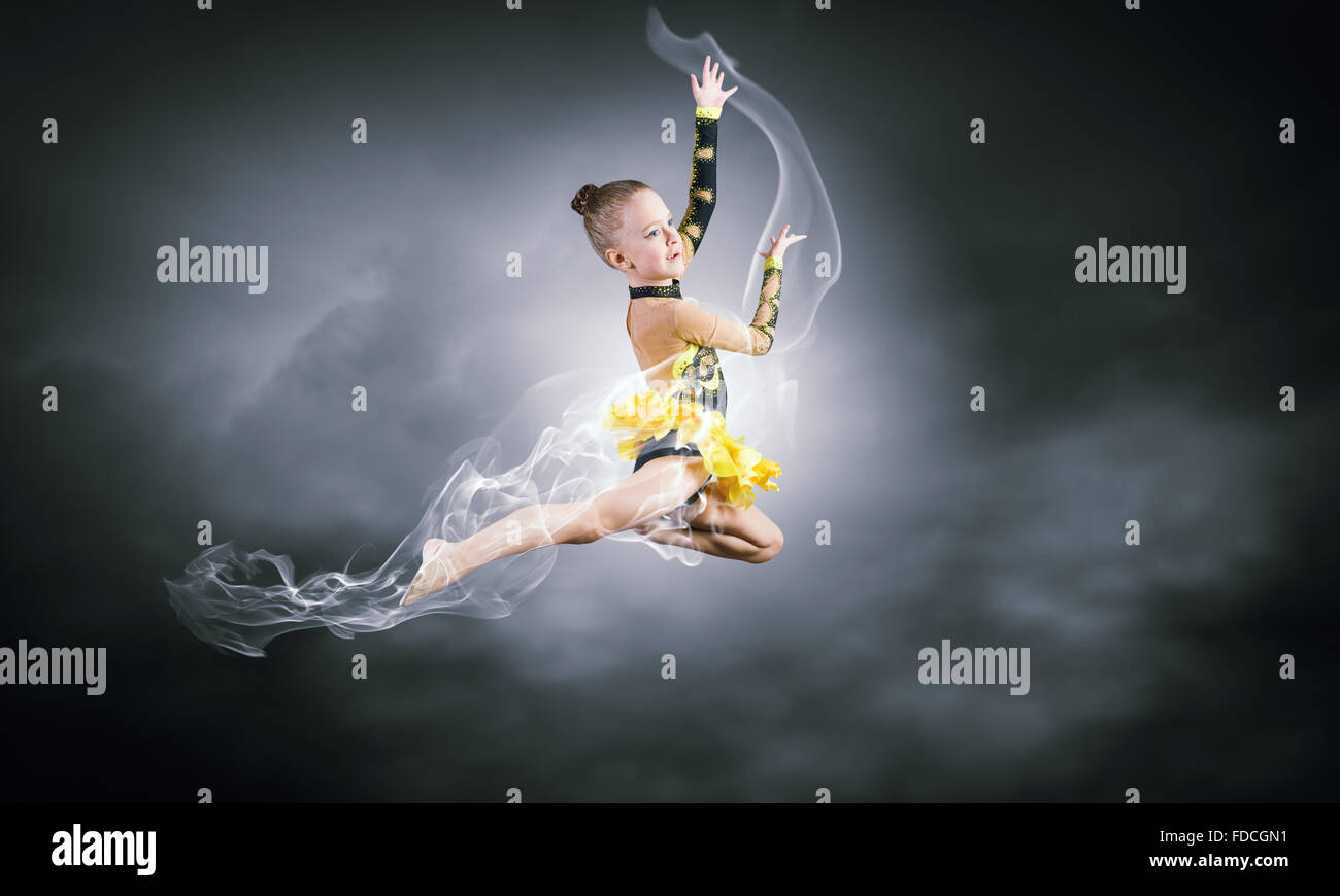 Little cute girl gymnast making high jump Stock Photo - Alamy