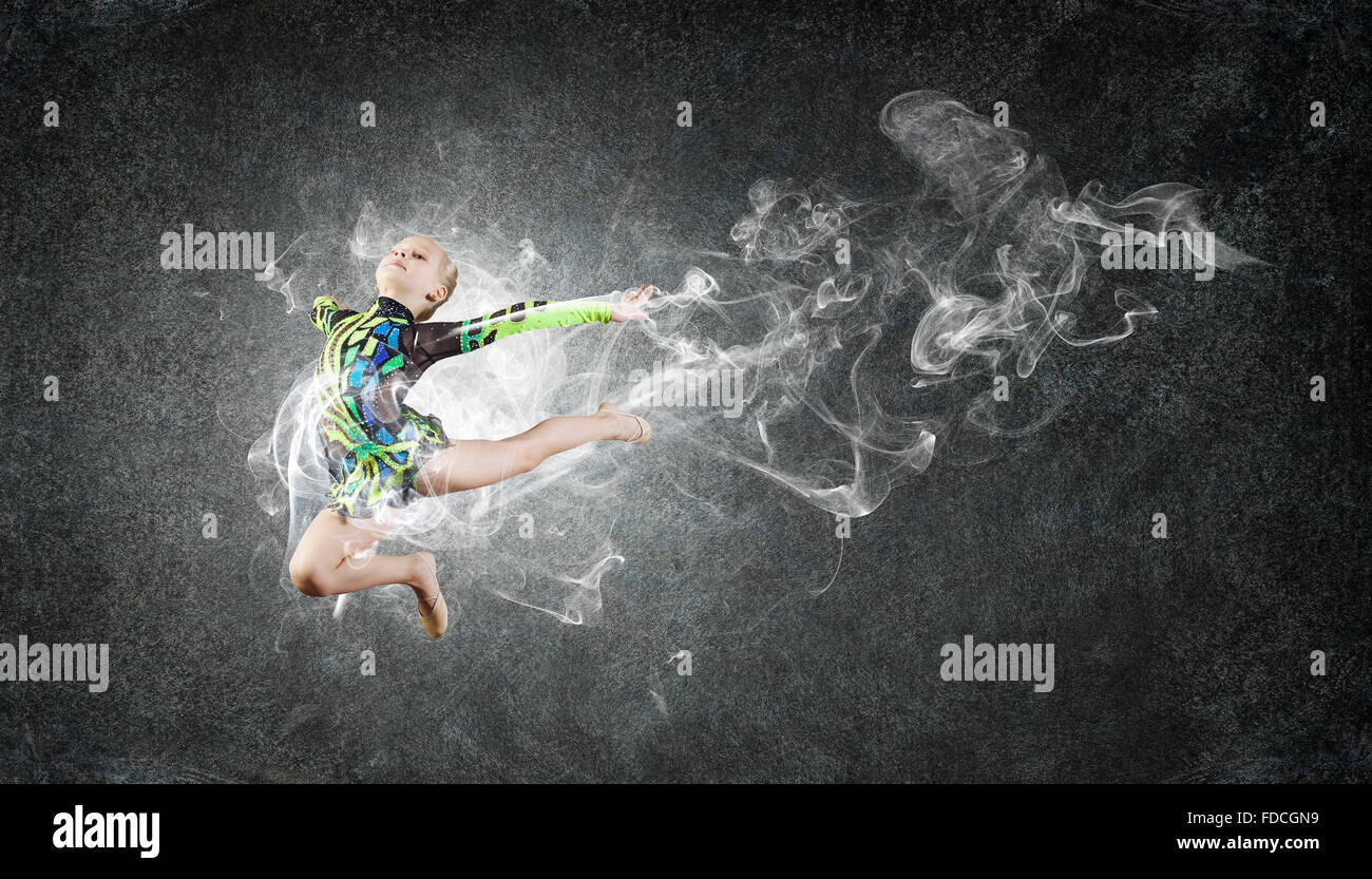 Little cute girl gymnast making high jump Stock Photo - Alamy