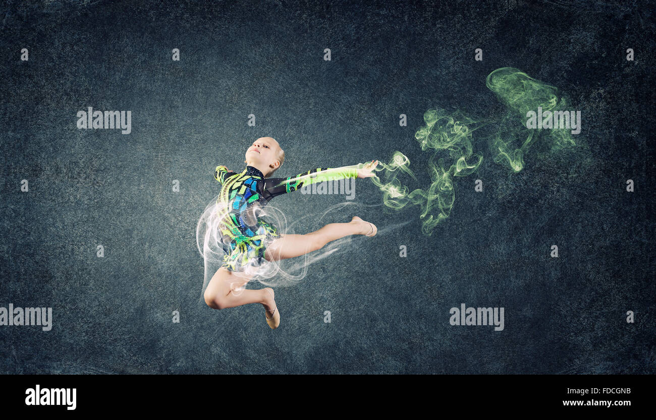 Little cute girl gymnast making high jump Stock Photo - Alamy