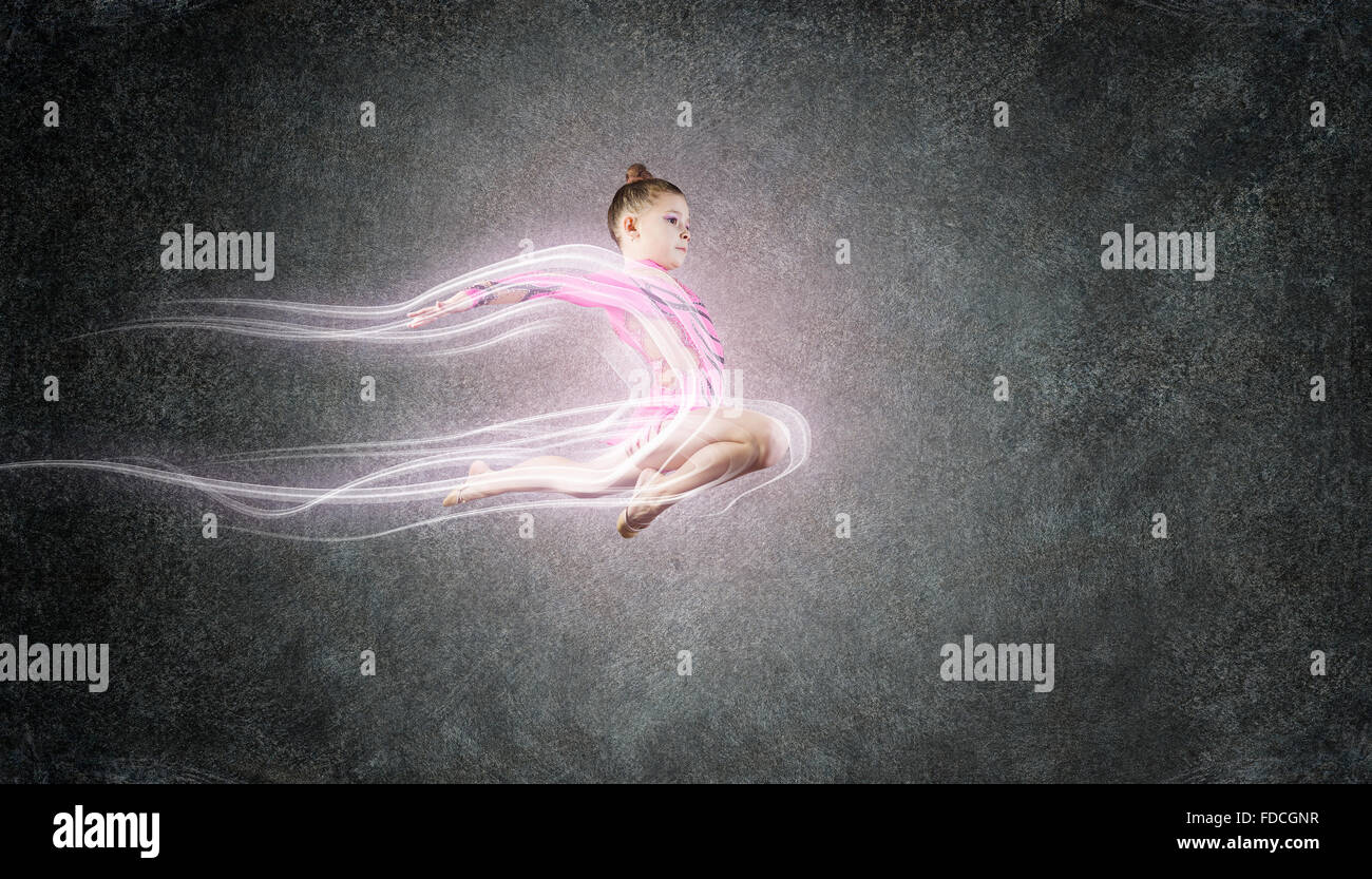 Little cute girl gymnast making high jump Stock Photo - Alamy