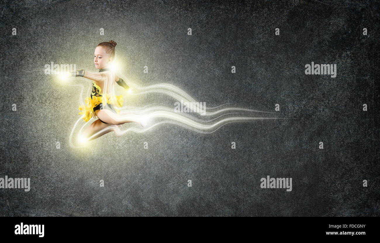 Little cute girl gymnast making high jump Stock Photo - Alamy