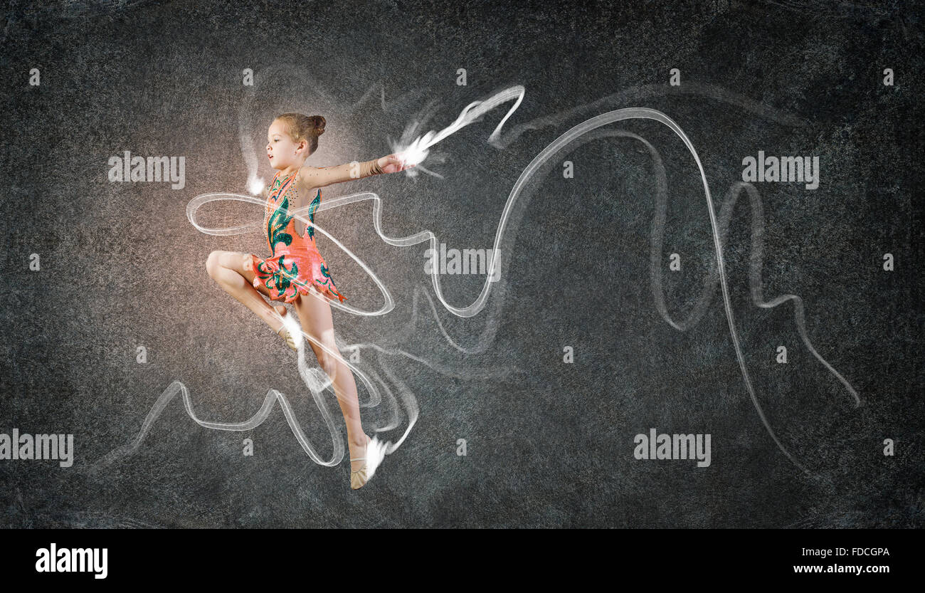 Little cute girl gymnast making high jump Stock Photo - Alamy