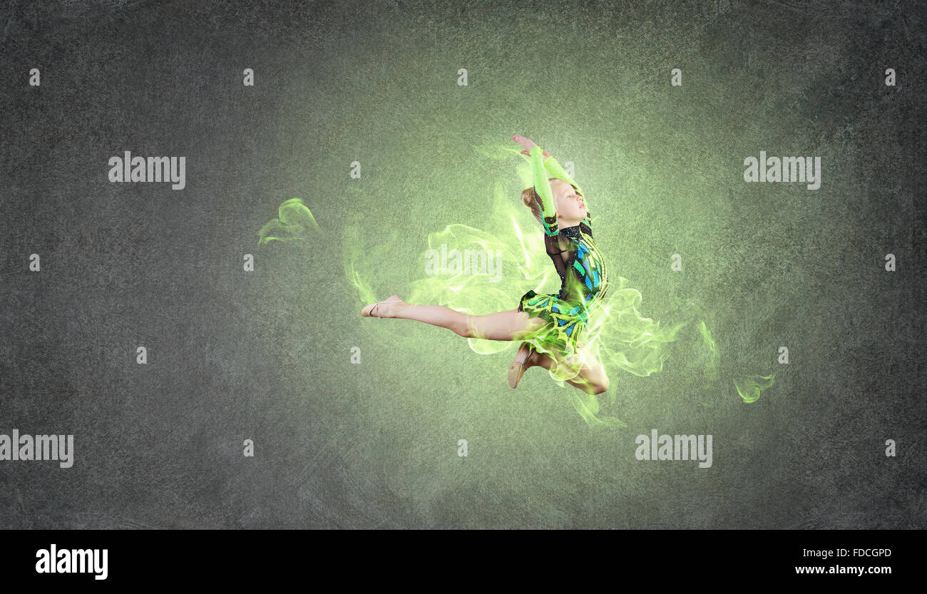 Little cute girl gymnast making high jump Stock Photo - Alamy