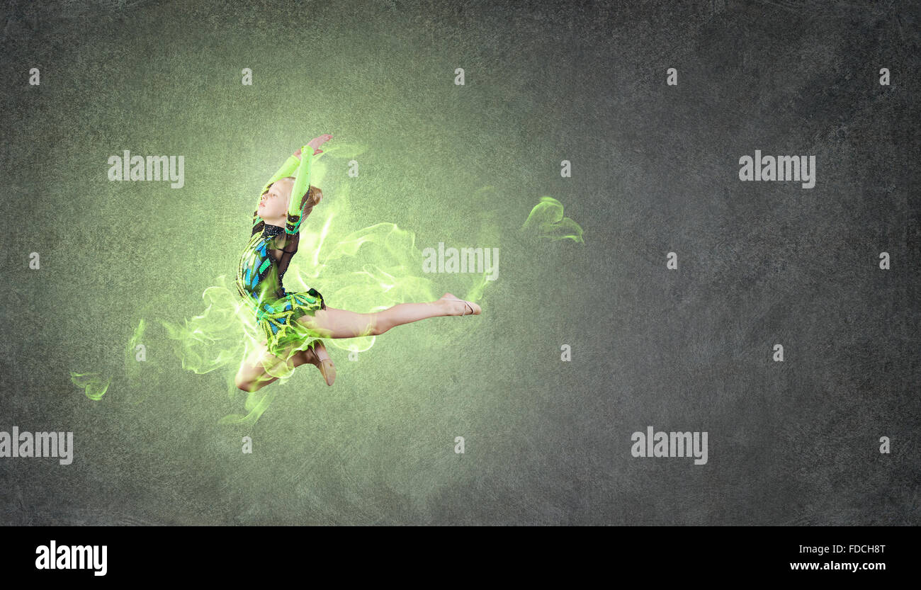 Little cute girl gymnast making high jump Stock Photo - Alamy