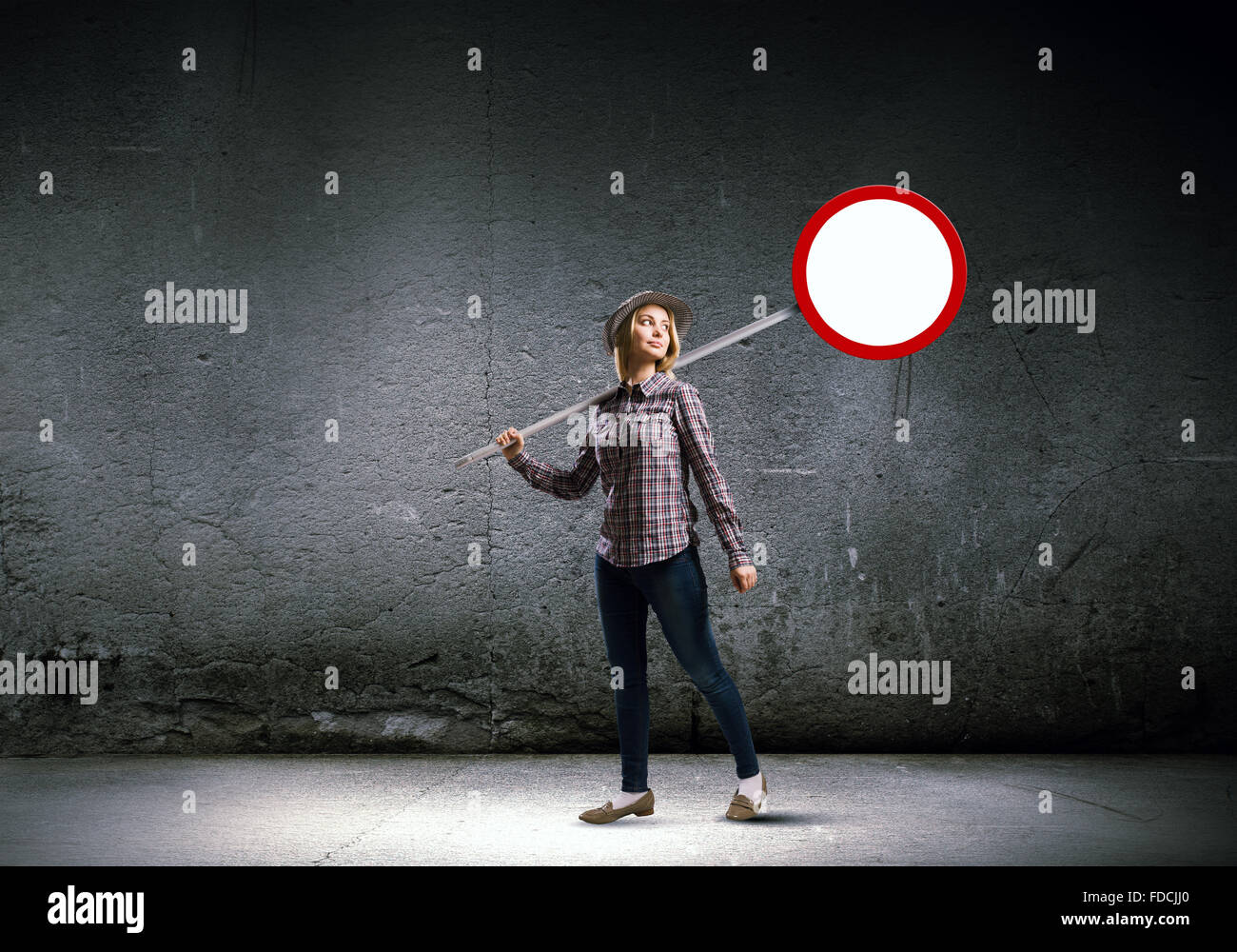 Young girl in casual holding stop sign Stock Photo - Alamy