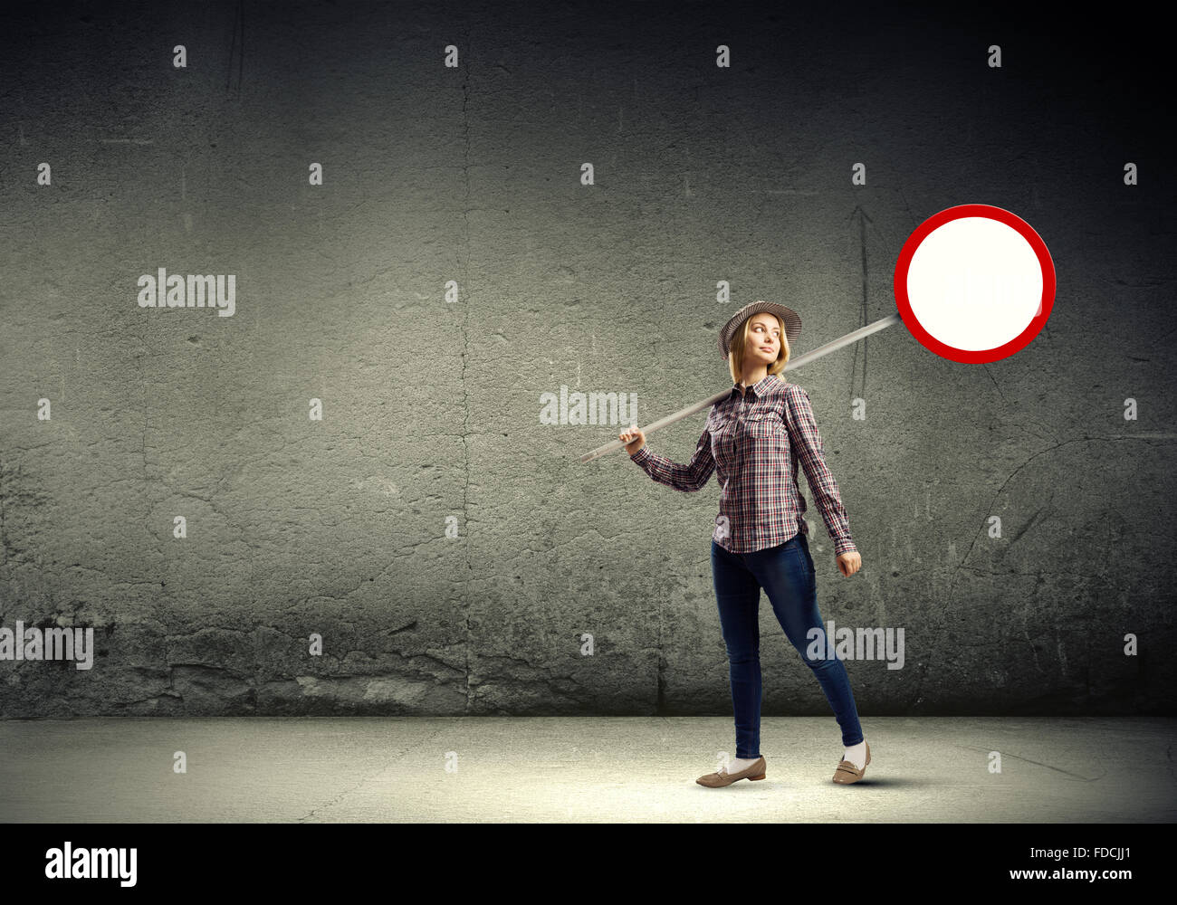 Young girl in casual holding stop sign Stock Photo - Alamy