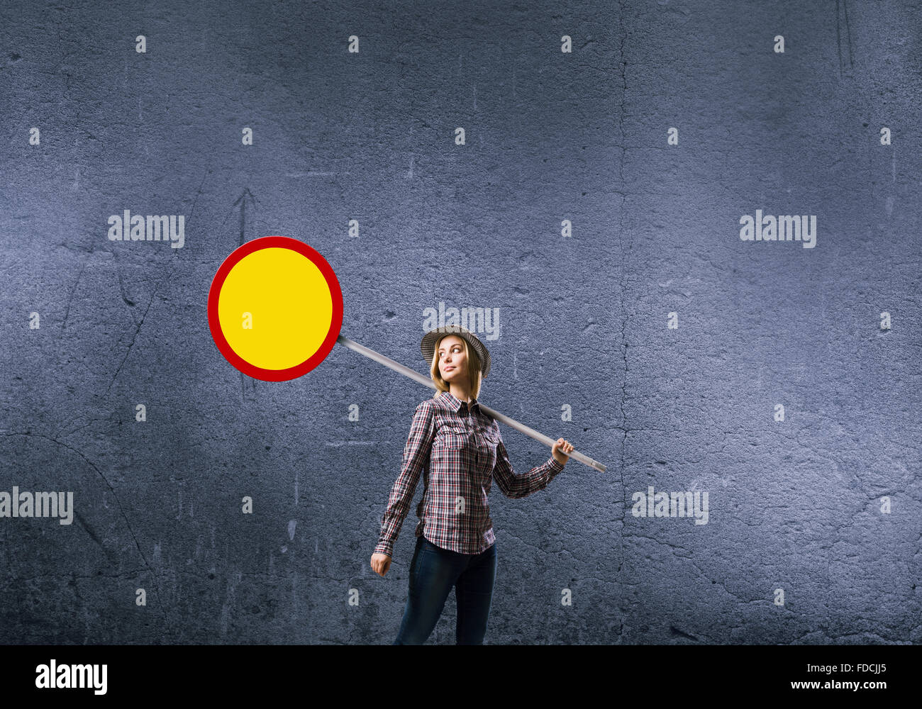 Young girl in casual holding stop sign Stock Photo - Alamy
