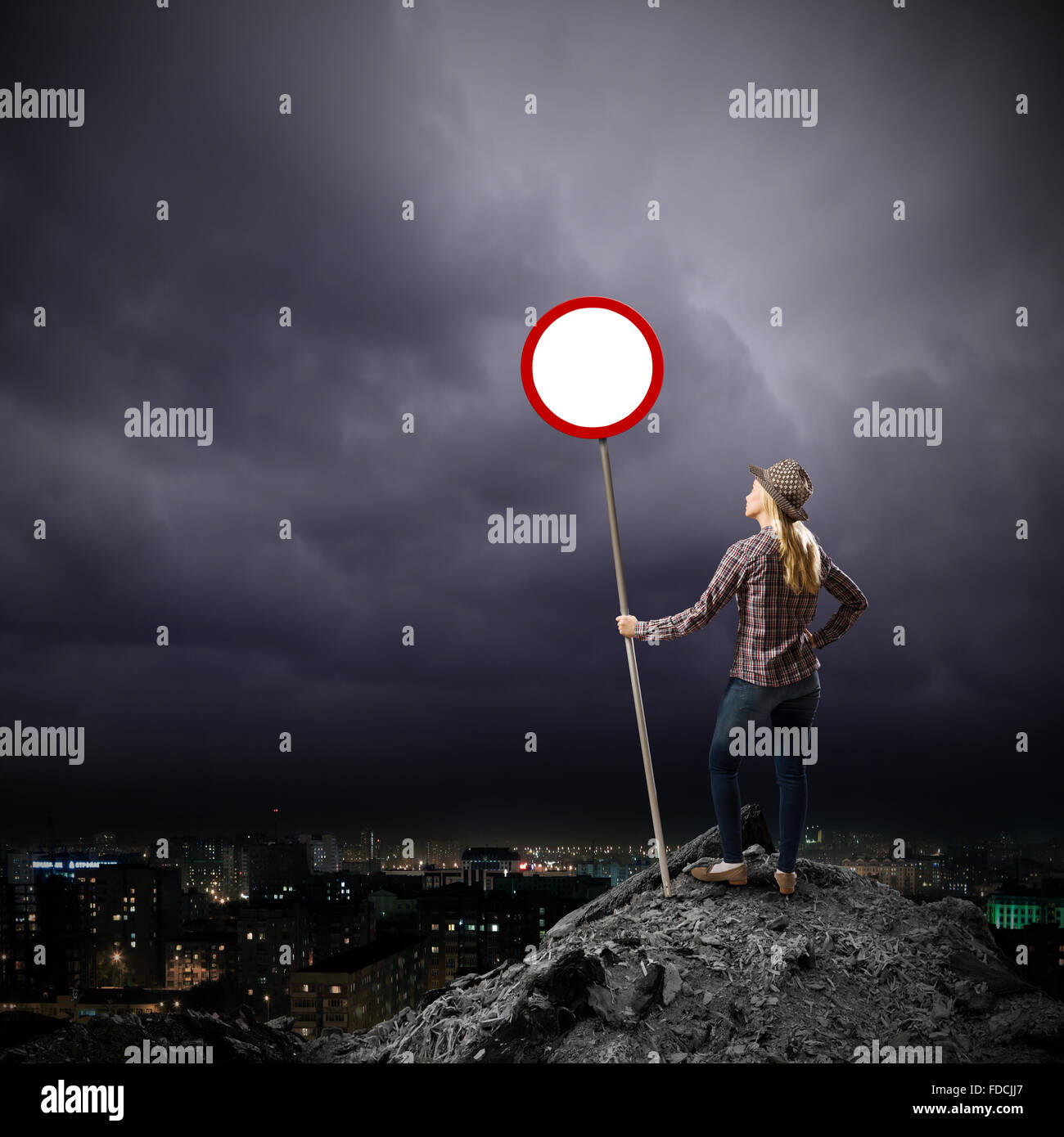 Young girl in casual holding stop sign Stock Photo - Alamy