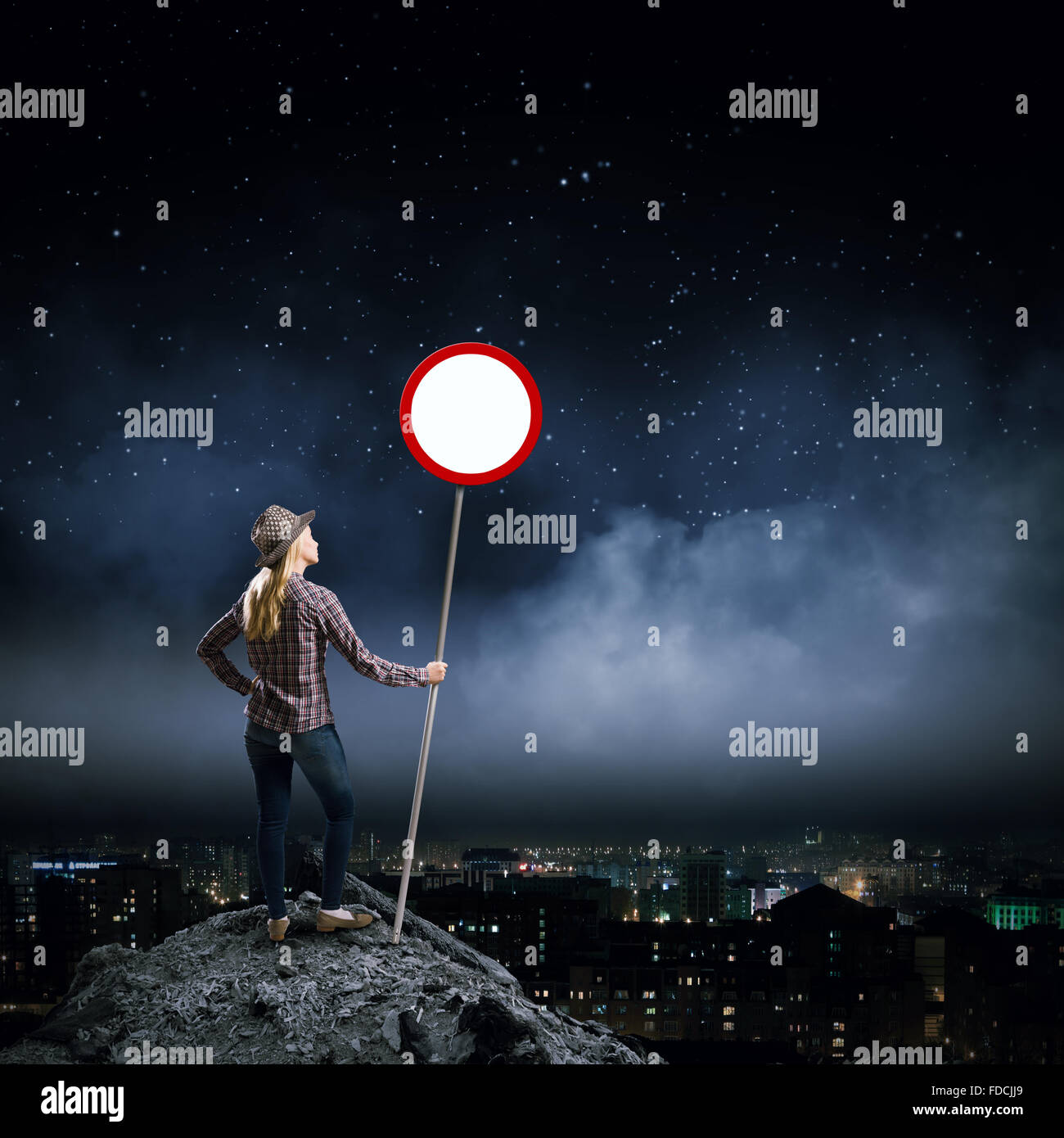 Young girl in casual holding stop sign Stock Photo - Alamy