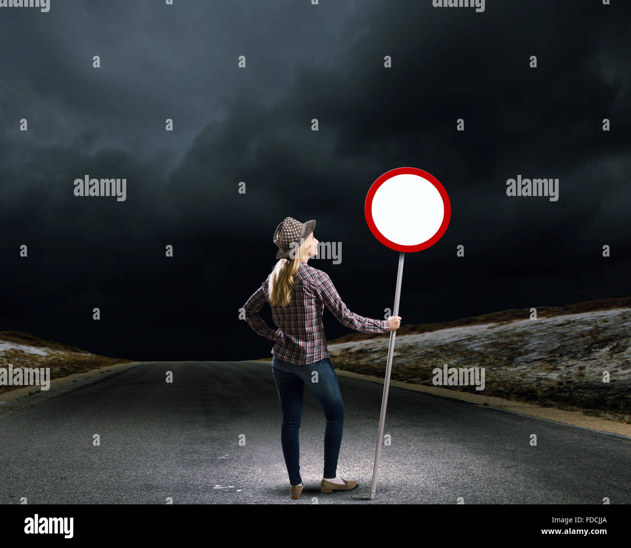 Young girl in casual holding stop sign Stock Photo - Alamy