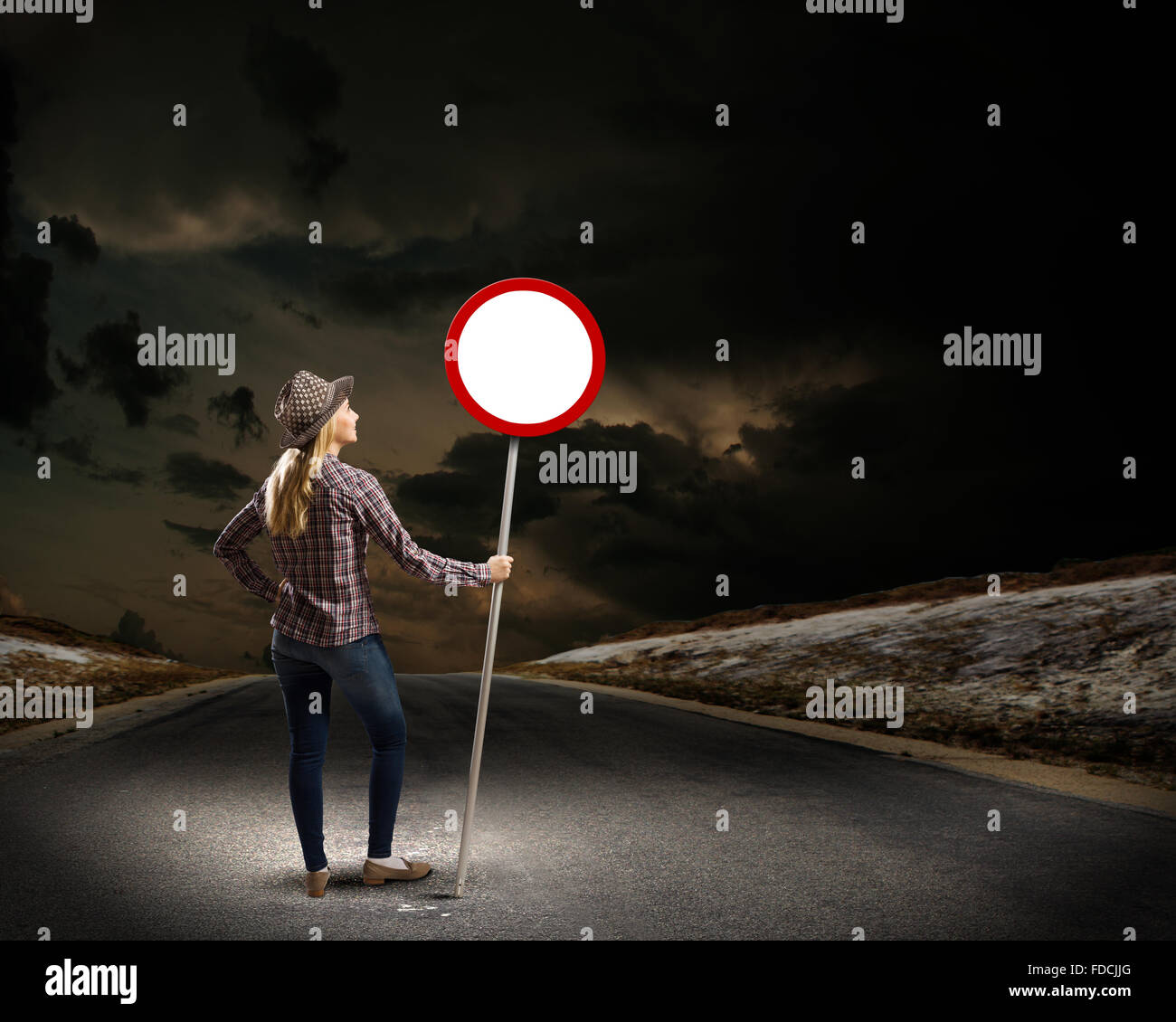 Young girl in casual holding stop sign Stock Photo - Alamy