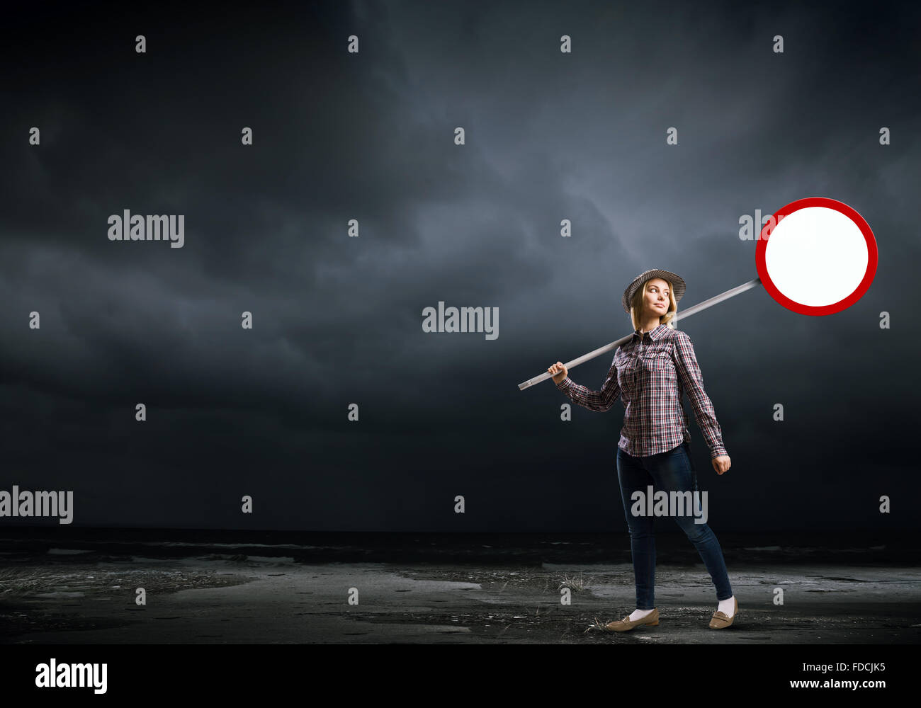 Young girl in casual holding stop sign Stock Photo - Alamy